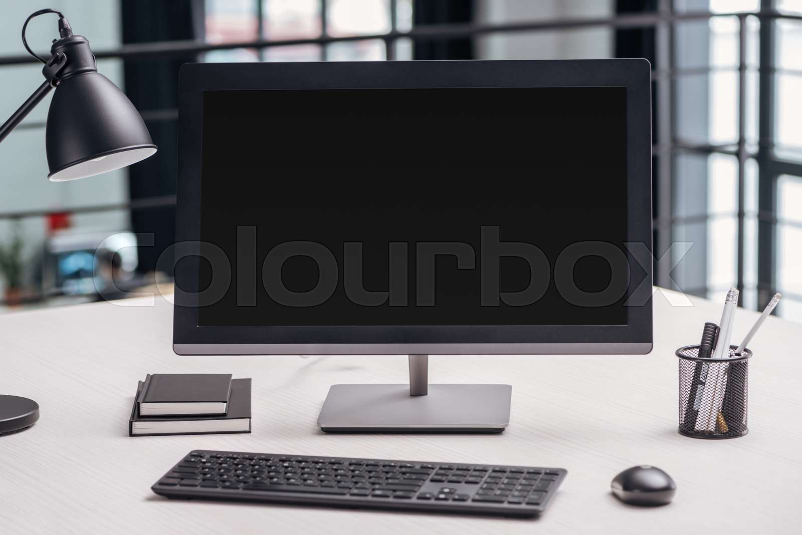 computer monitor with blank screen and stationery at workplace in ...