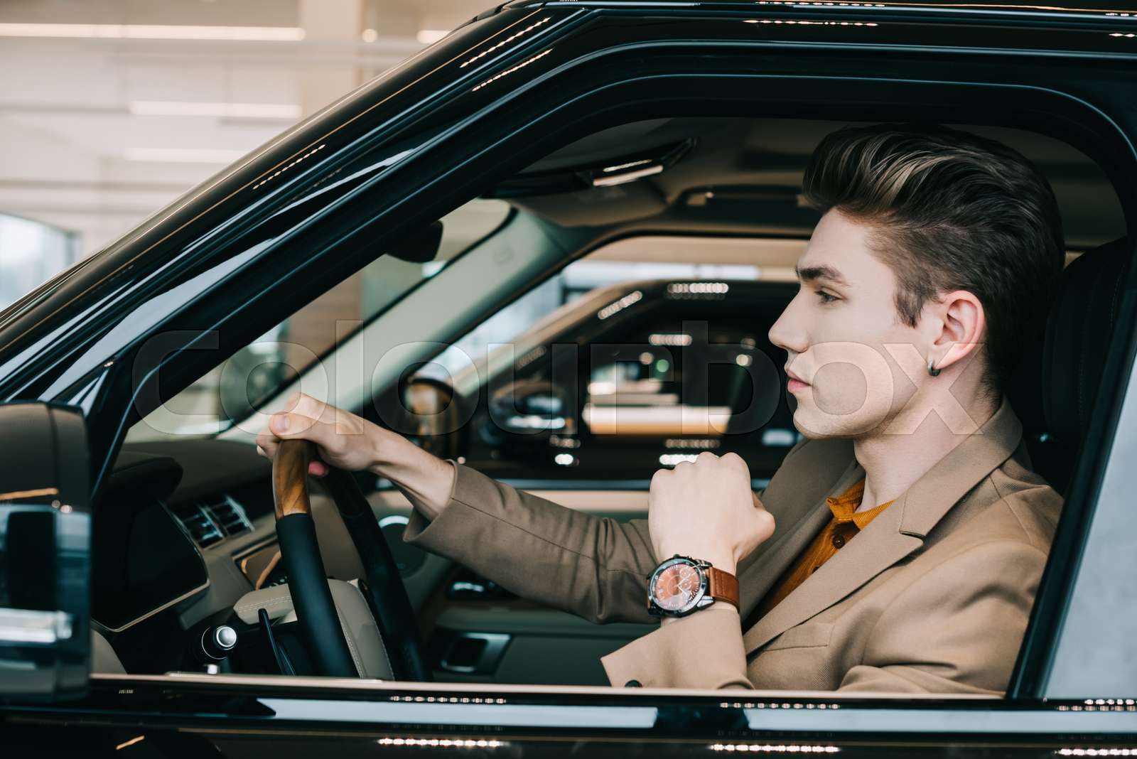 handsome man holding steering wheel while driving car | Stock image ...
