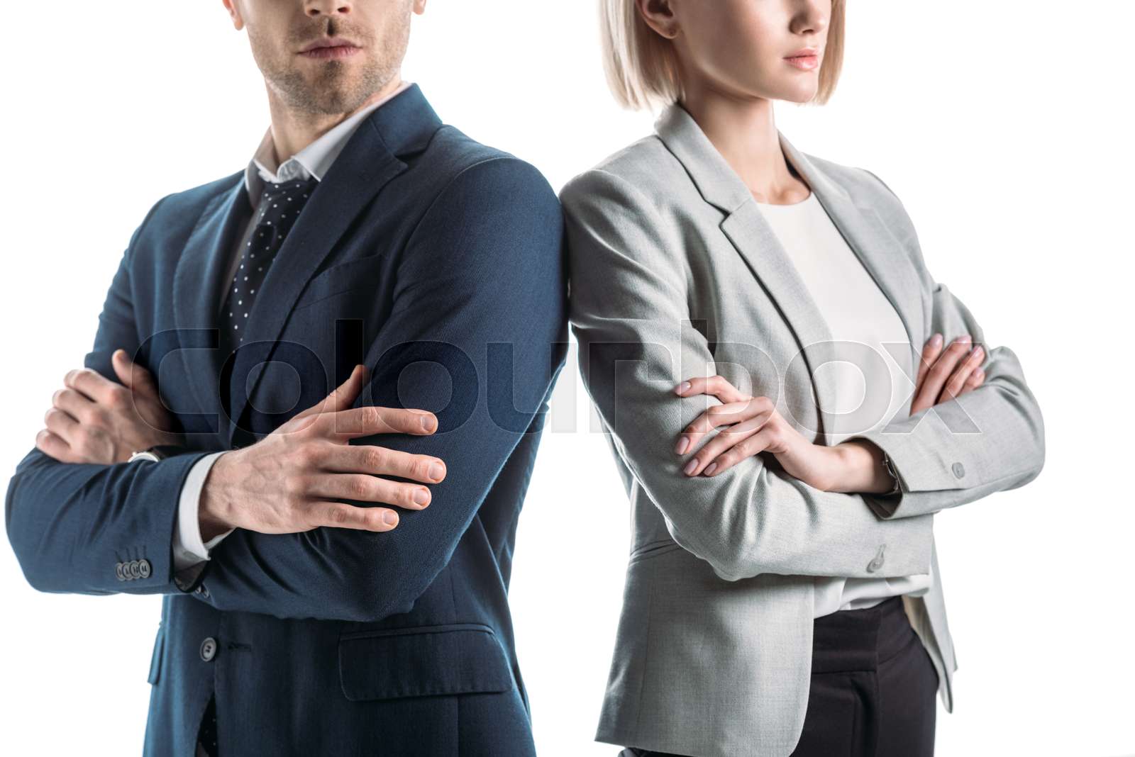partial view of businesswoman and businessman standing shoulder to ...