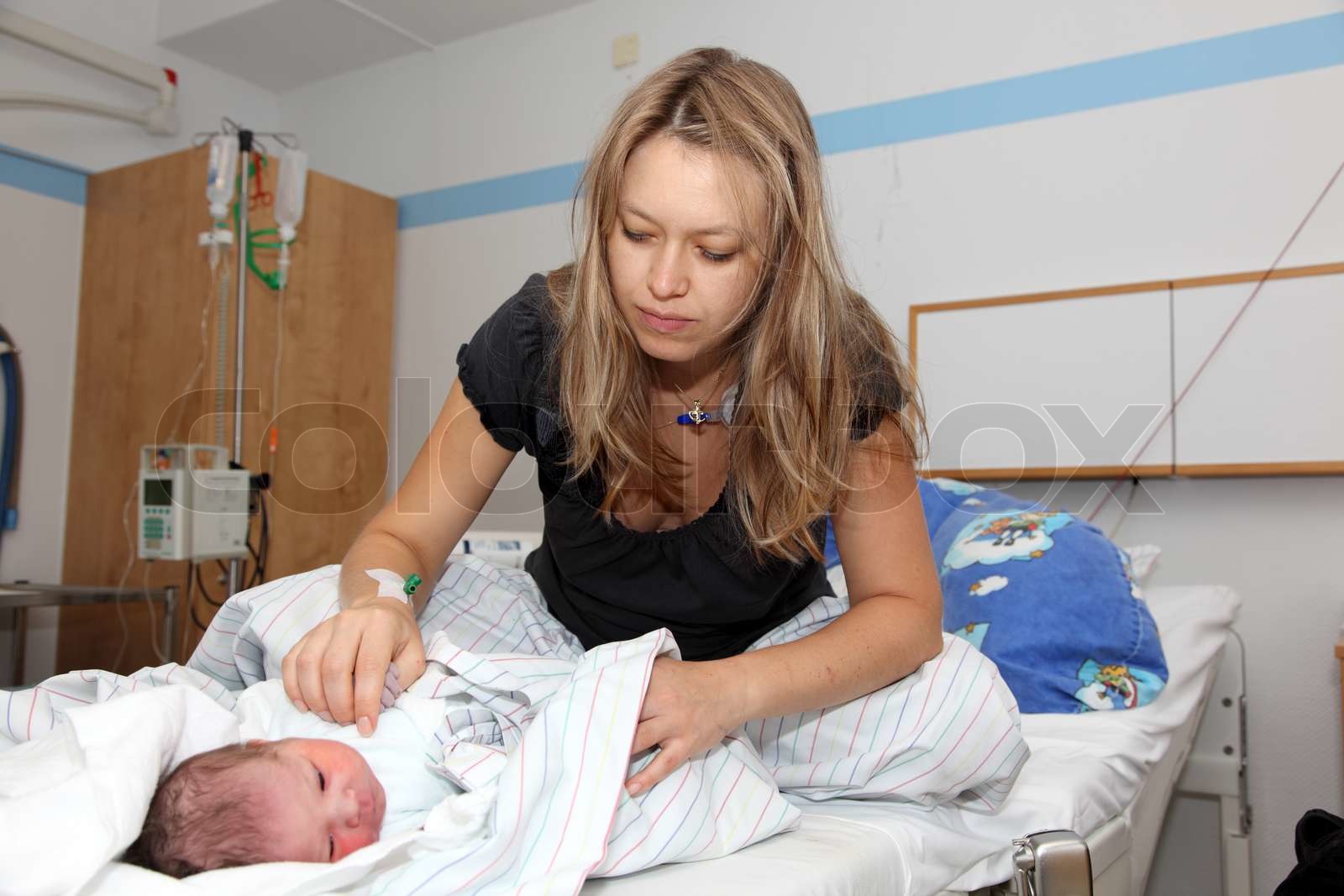 Exhausted mother with newborn baby in delivery room | Stock image ...