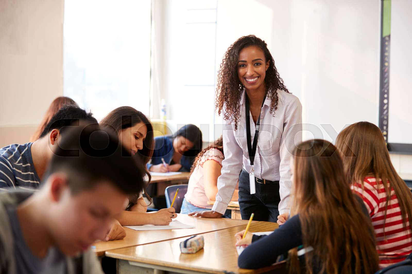Portrait Of Smiling Female High School Teacher Standing By Student ...