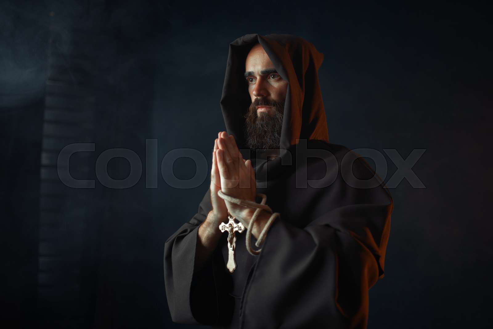 Medieval monk praying with closed eyes | Stock image | Colourbox