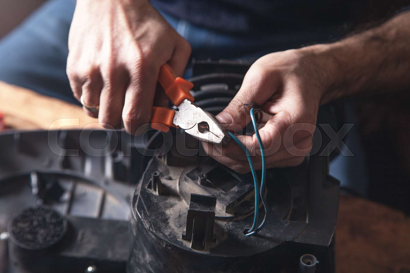Electrician cutting cable with cutters. | Stock image | Colourbox