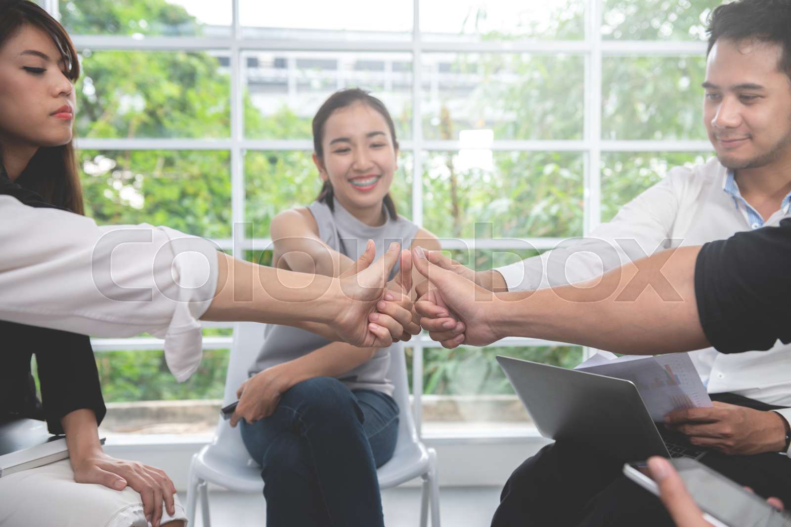 Asian business people group join the hand for collaboration and support ...