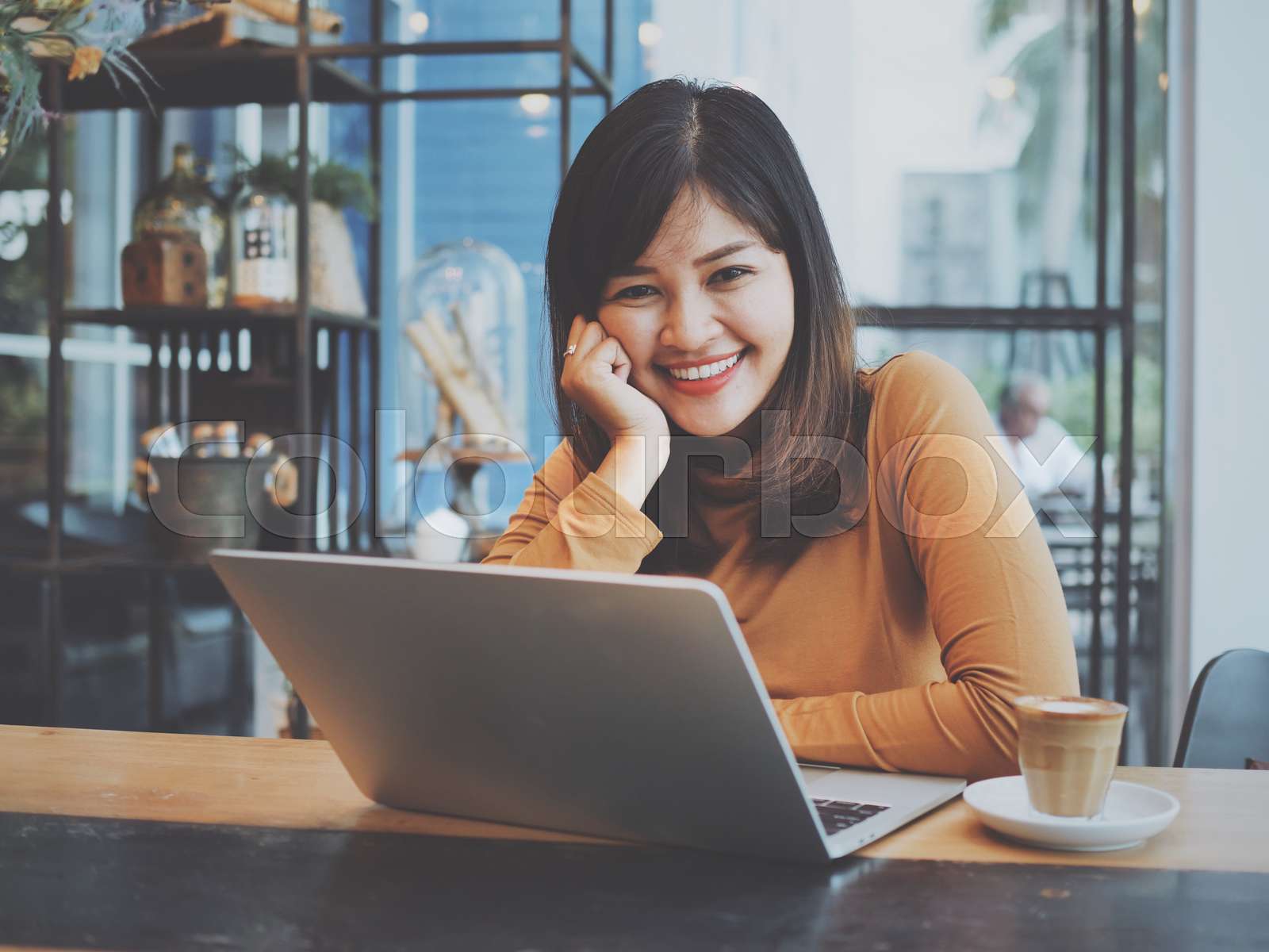 Asian woman using laptop in coffee shop cafe | Stock image | Colourbox