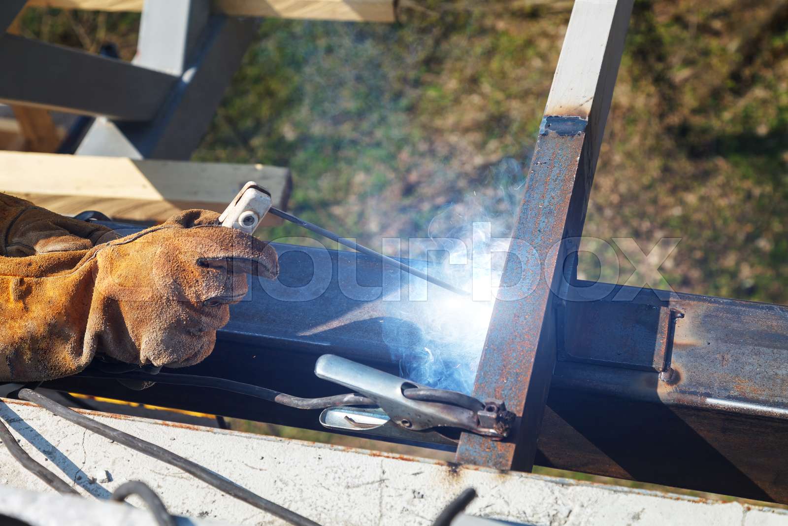 Worker welding in a factory. Welding on an industrial plant. | Stock ...