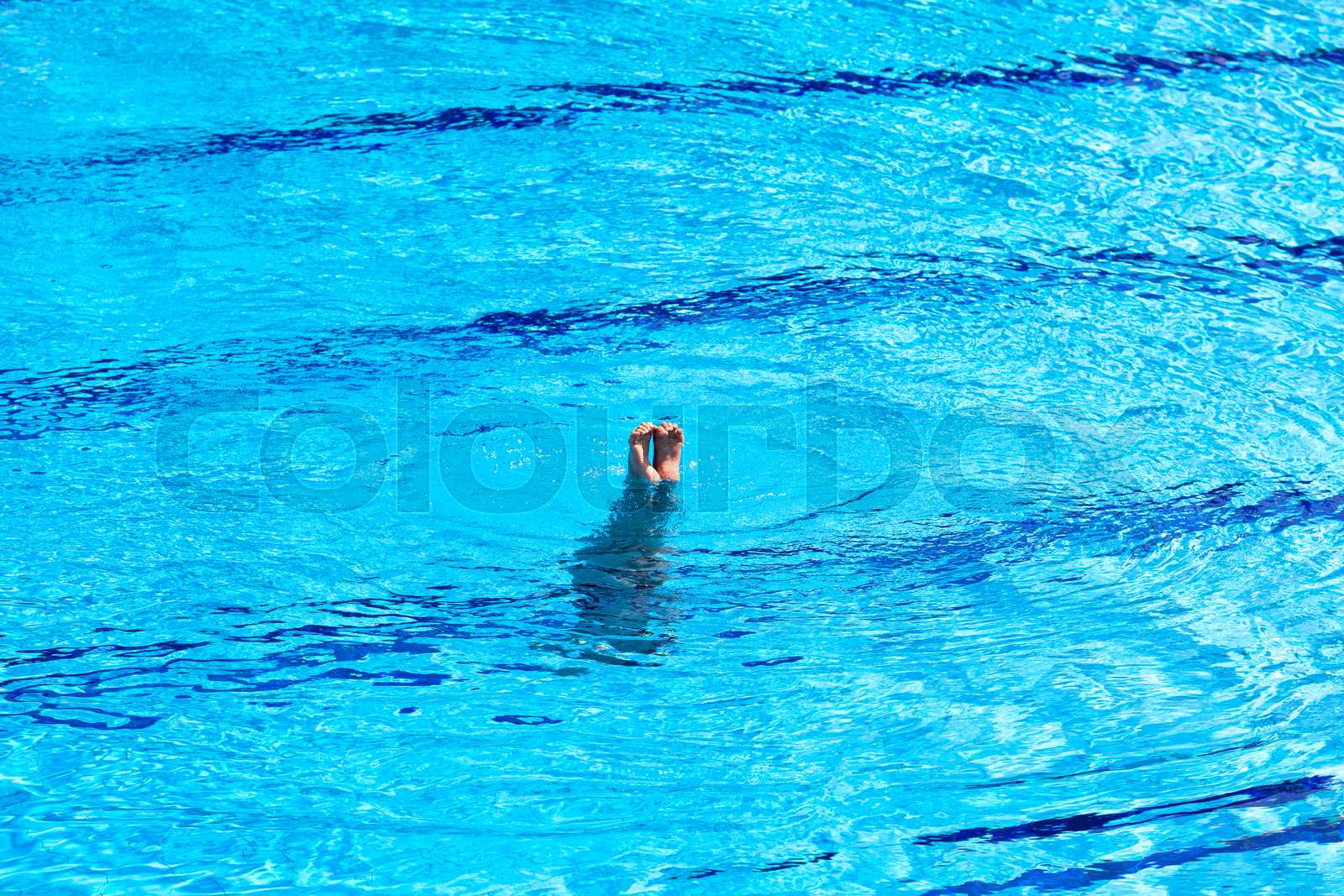 Feet of woman doing a handstand inside swimming pool | Stock image ...