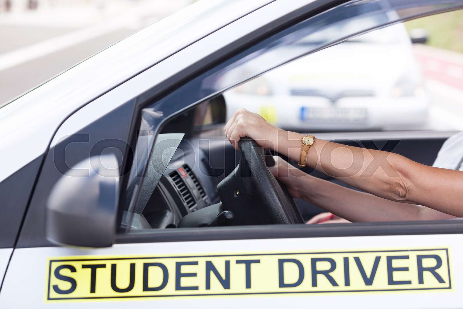 Learner driver holding steering wheel during driving lesson | Stock ...