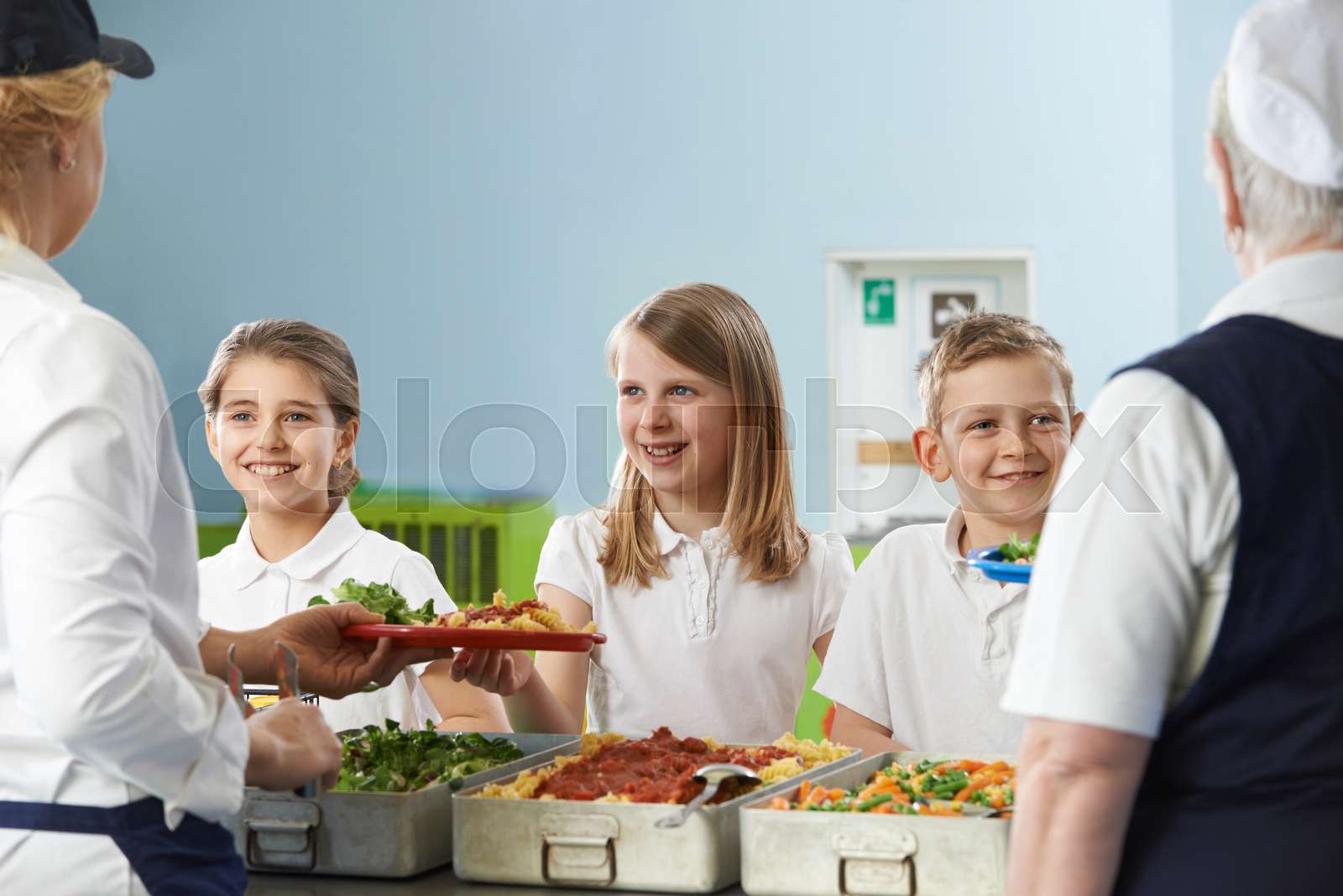 Pupils In School Cafeteria Being Served Lunch By Dinner Ladies | Stock ...