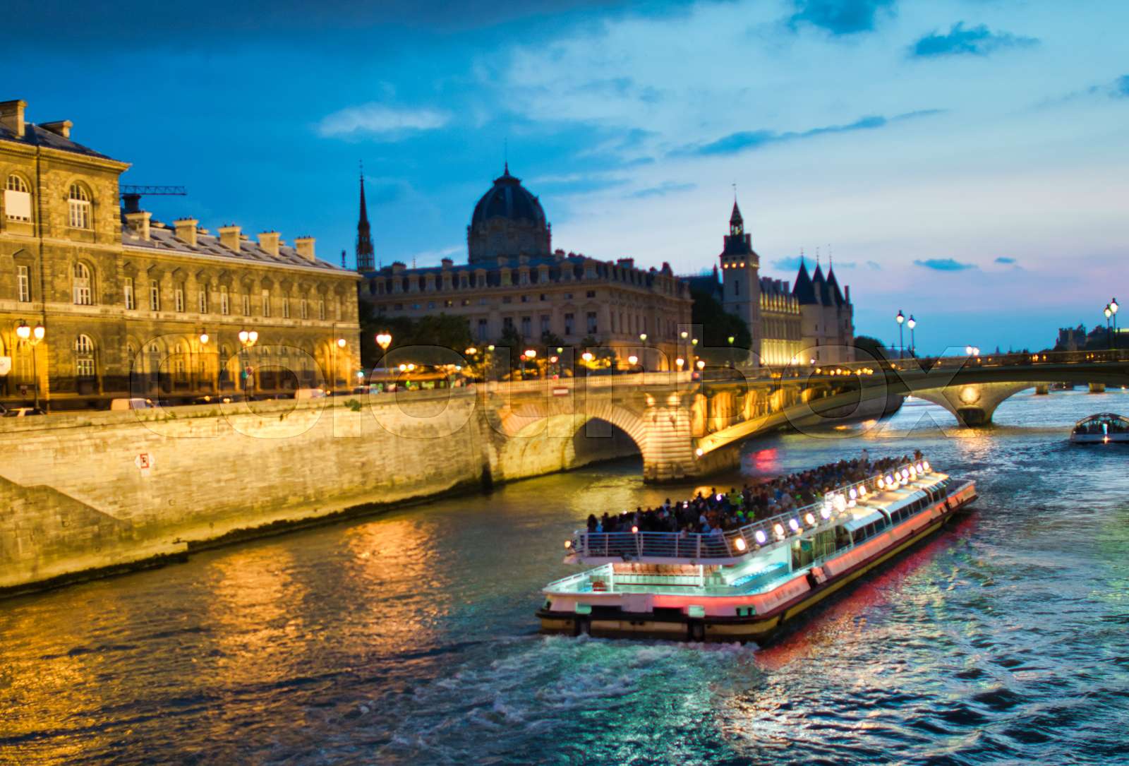 PARIS - JULY 2014: Bateau Mouche at night along the Seine River with ...