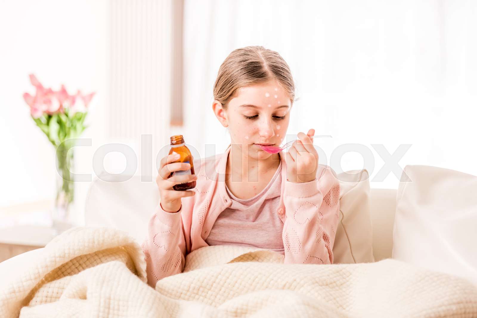 Teen girl taking syrup to cure | Stock image | Colourbox