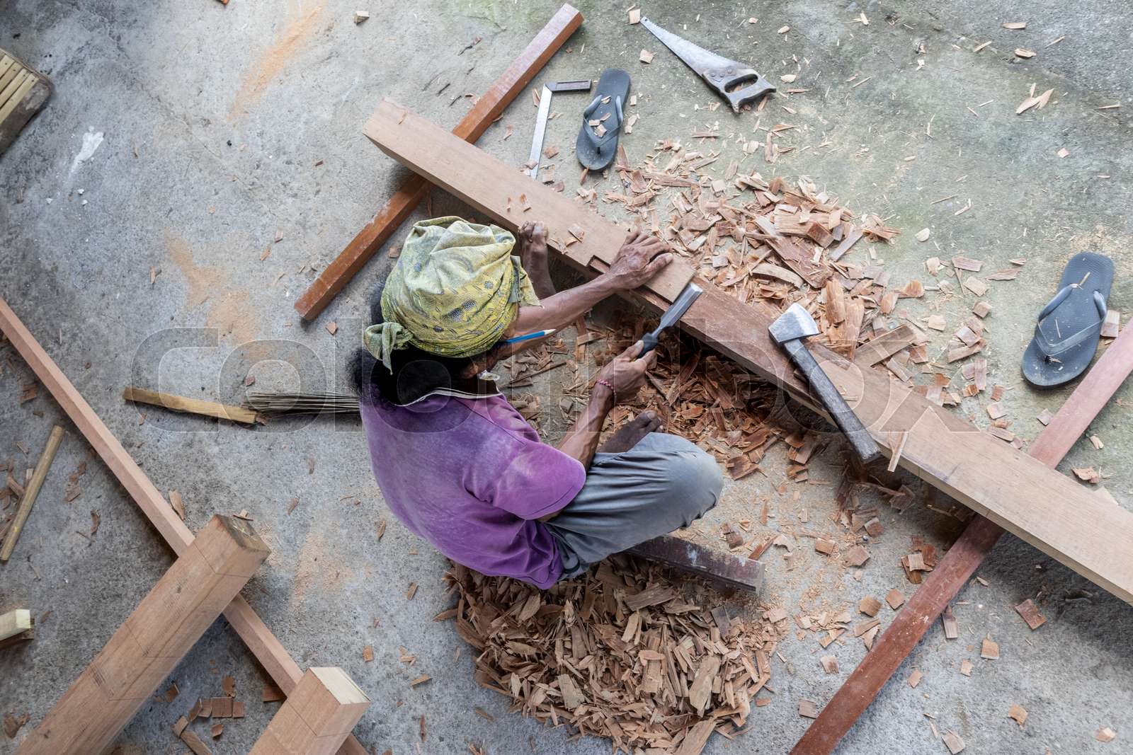 Carpenter working in traditional manual carpentry shop in a third world ...