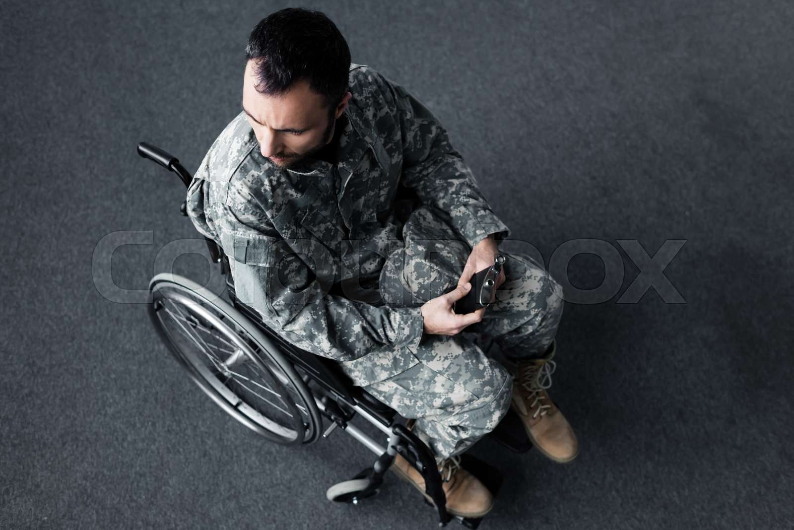 overhead view of disabled man in uniform sitting in wheelchair and ...