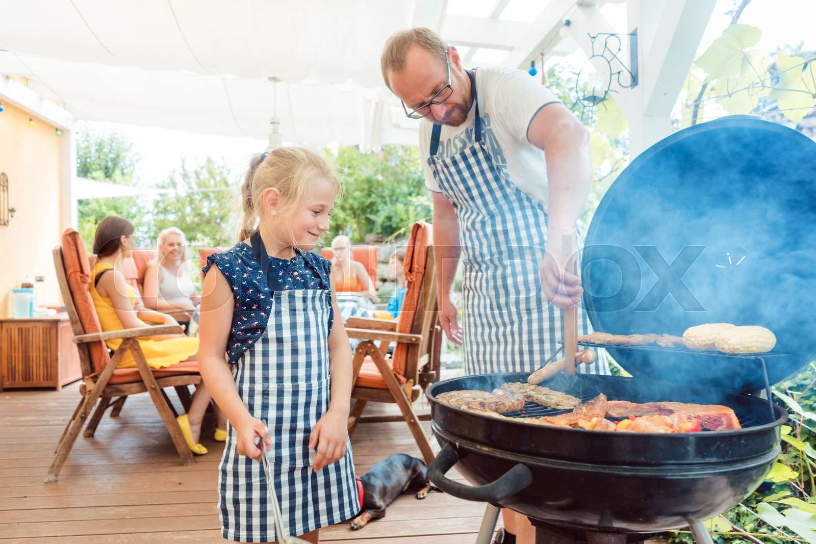 Dad and kid doing the barbeque at the grill | Stock image | Colourbox