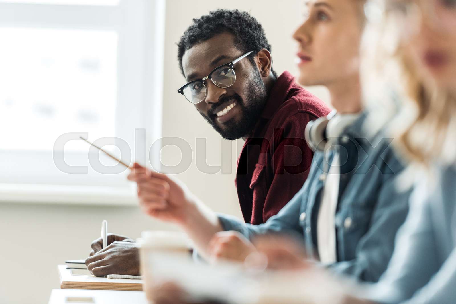 smiling african american student in glasses looking at camera | Stock ...