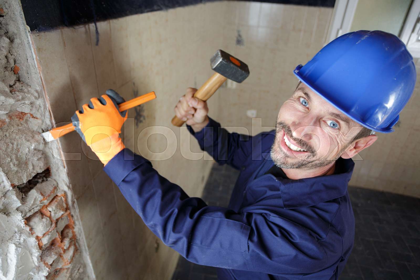 builder using hammer and chisel | Stock image | Colourbox