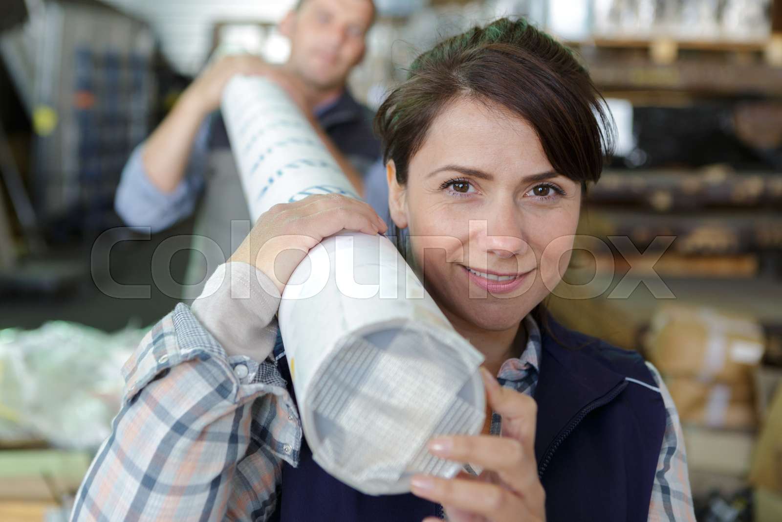 woman carrying papers in factory | Stock image | Colourbox