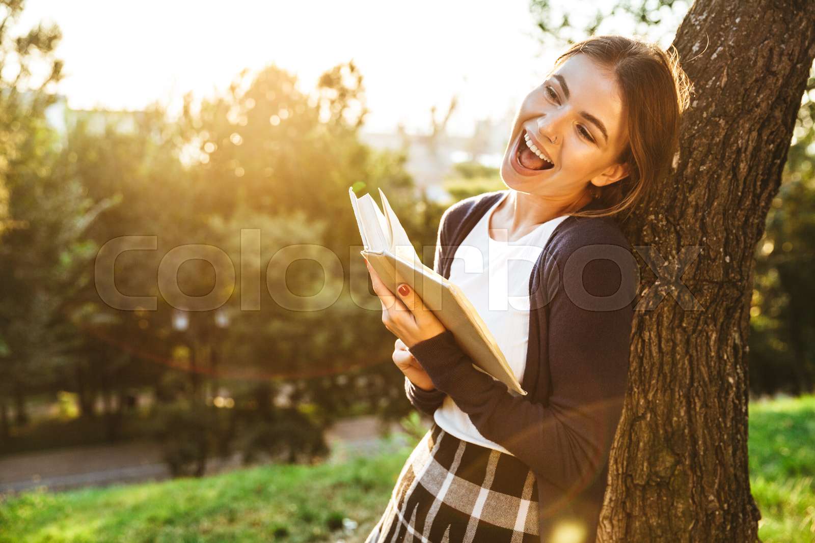 Beautiful young girl holding book | Stock image | Colourbox