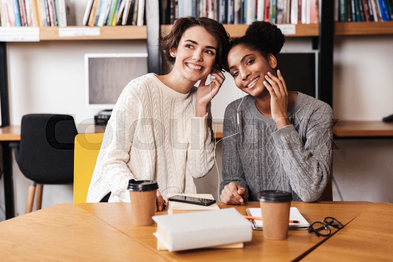 Two cheerful young girls students studying | Stock image | Colourbox