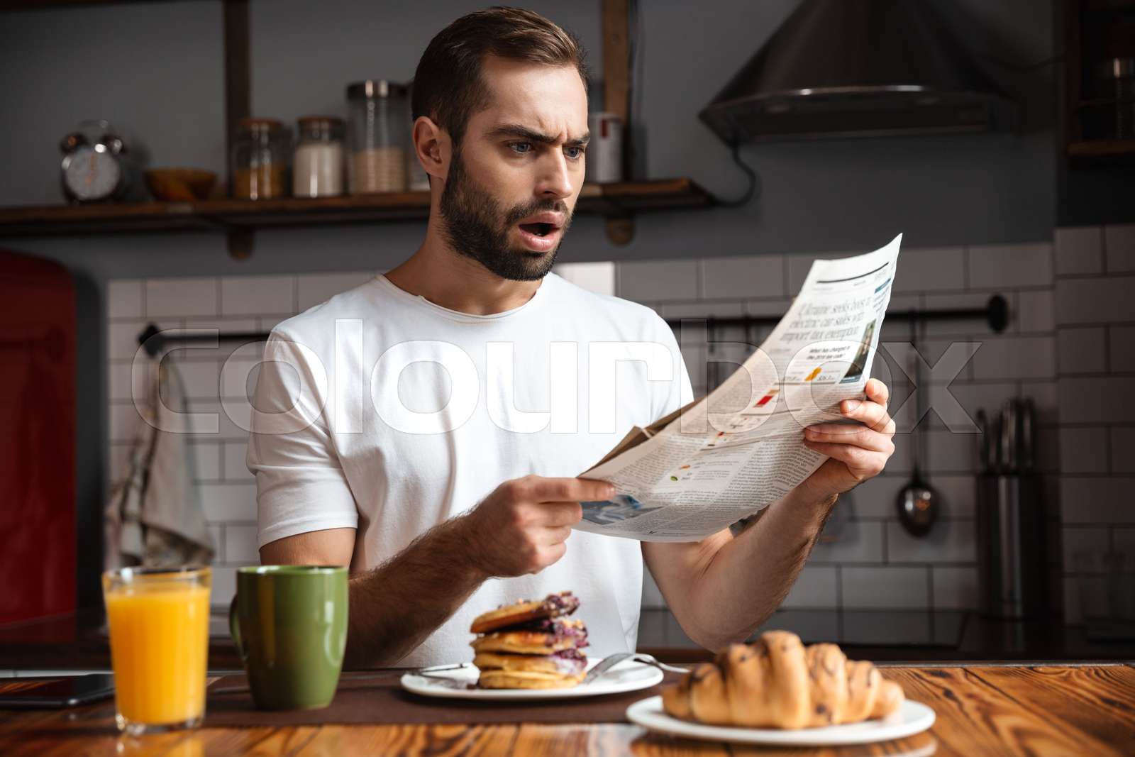 Angry shocked man having breakfast | Stock image | Colourbox