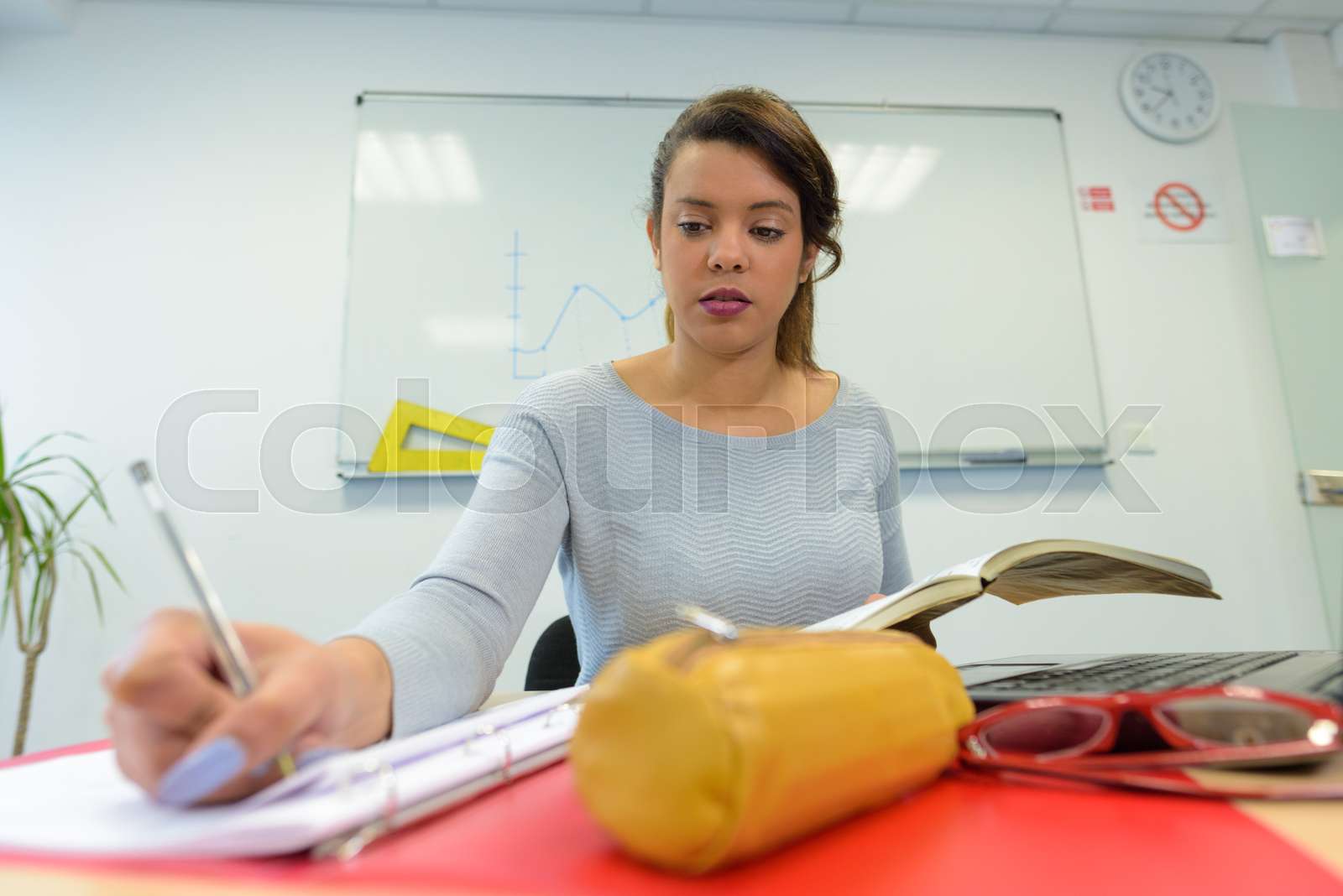 teacher checking students works | Stock image | Colourbox