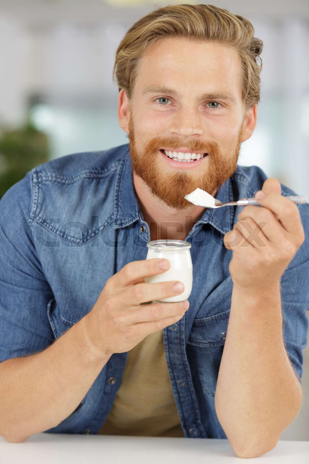 healthy eating young man yogurt in the kitchen | Stock image | Colourbox