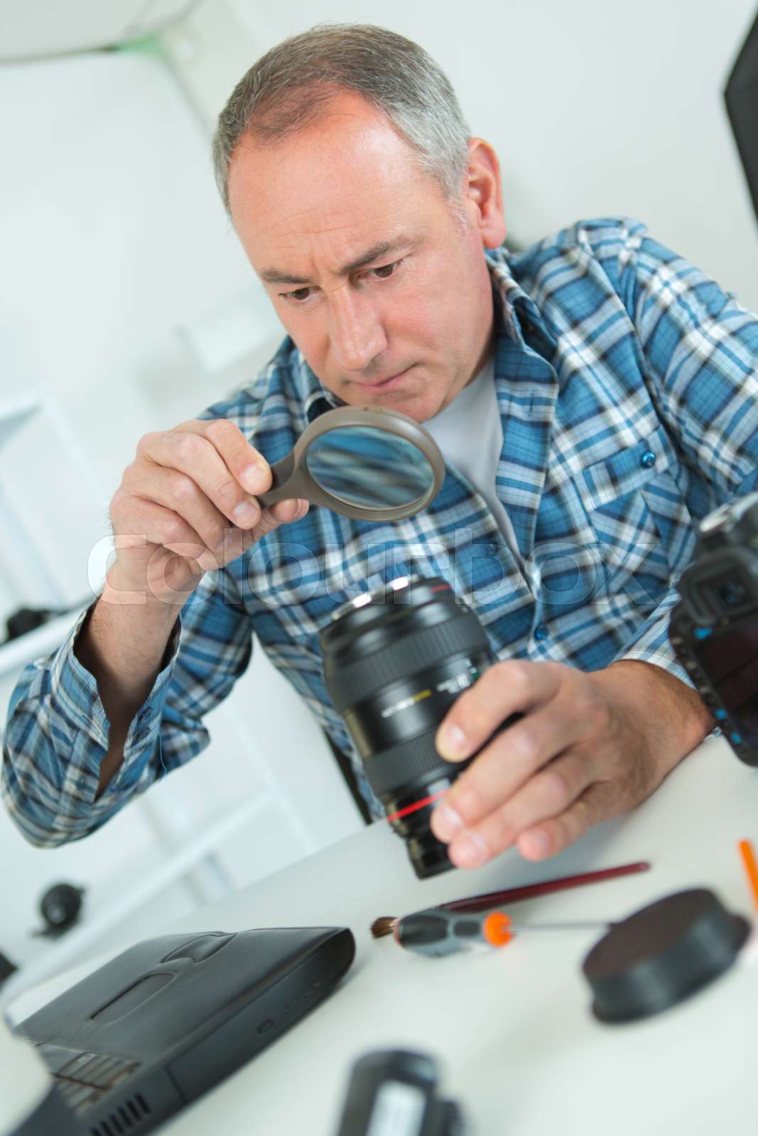 man fixing camera | Stock image | Colourbox