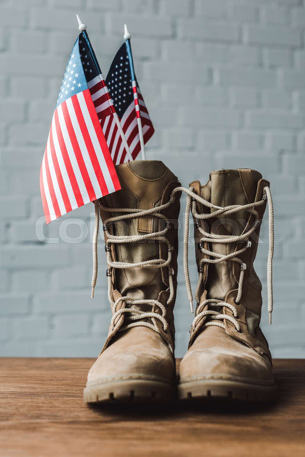 military boots and american flags with stars and stripes on wooden ...