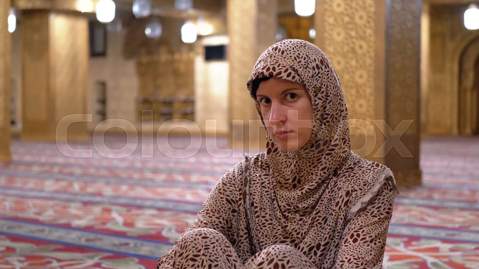Nun in Robe Sits on a Carpet Inside an Islamic Mosque. Egypt | Stock ...