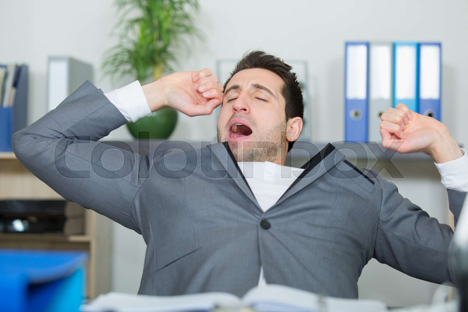 businessman yawning while working | Stock image | Colourbox