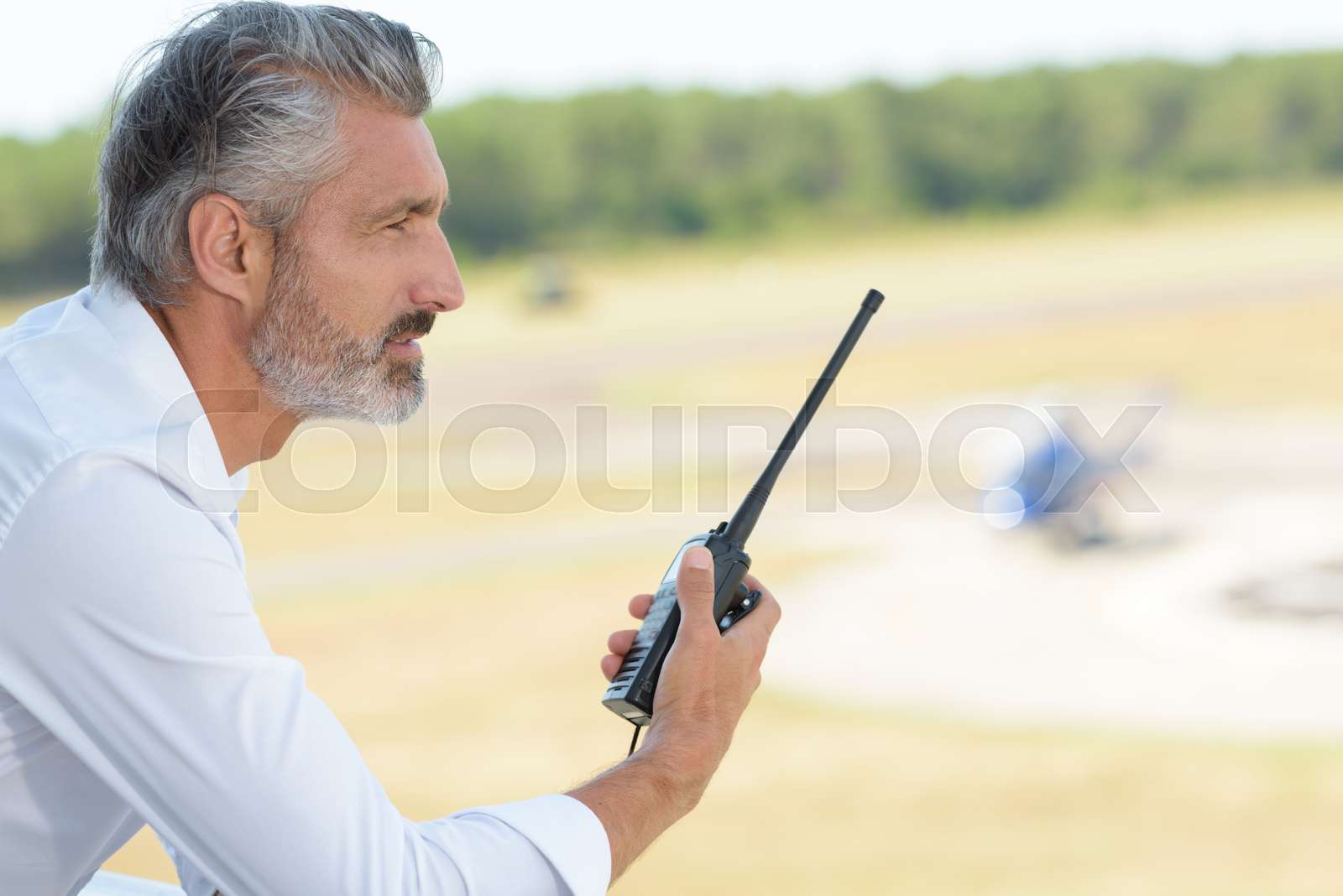 male worker using walkie-talkie | Stock image | Colourbox