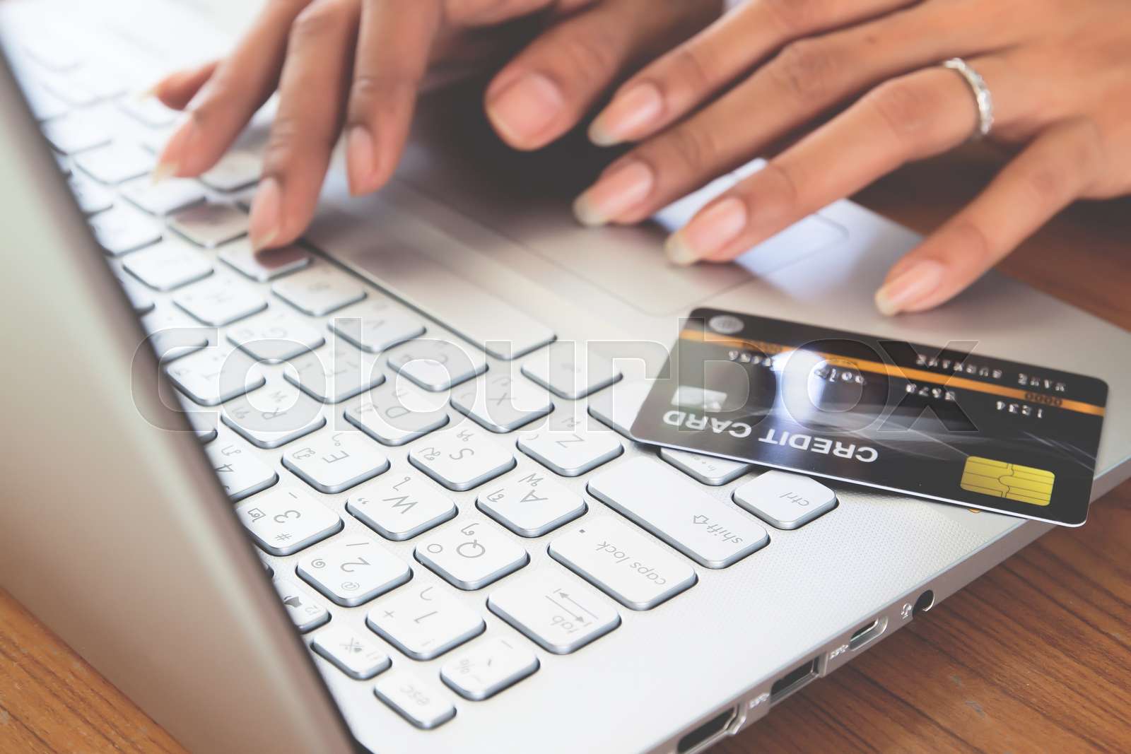 Woman hands using laptop computer with plastic credit card on keyboard ...