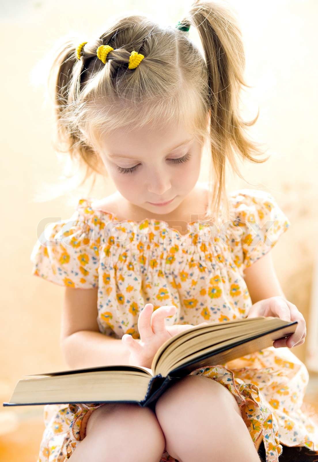 little girl reading book | Stock image | Colourbox