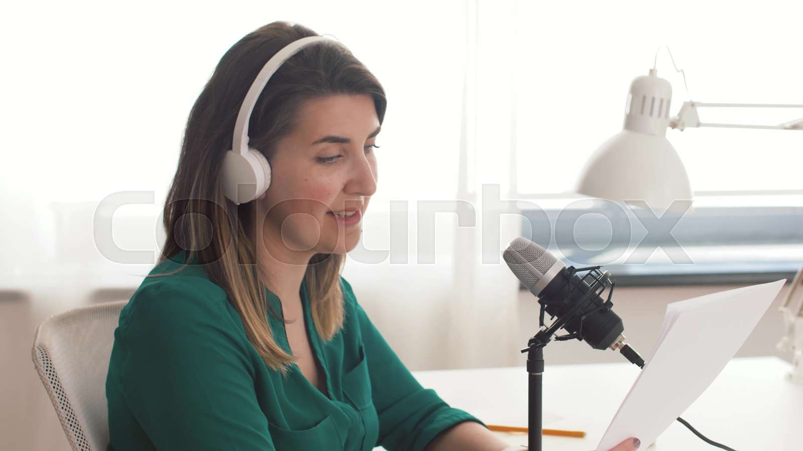woman with microphone recording podcast at studio | Stock video | Colourbox