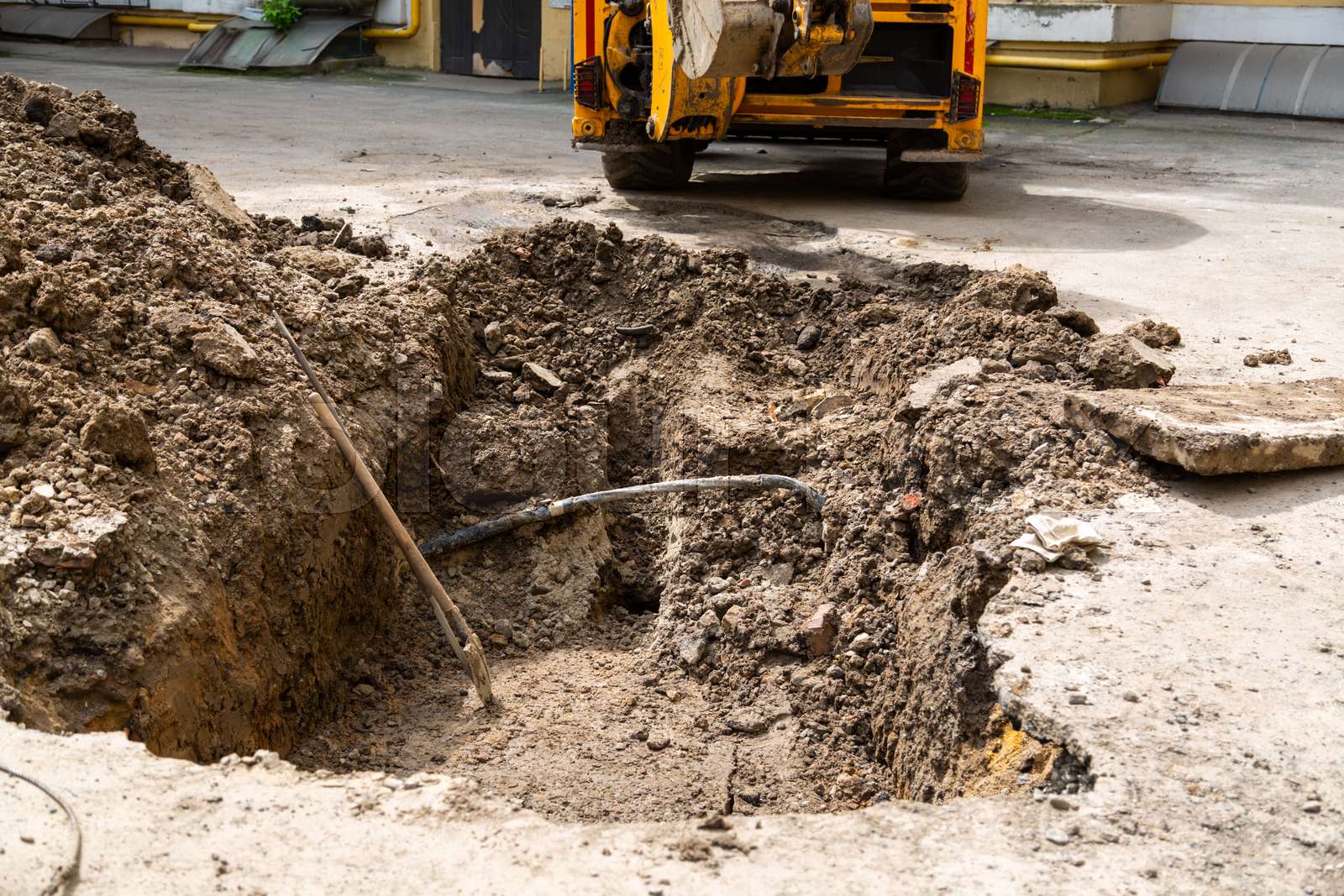 Pit excavated by an excavator. Repair work. | Stock image | Colourbox