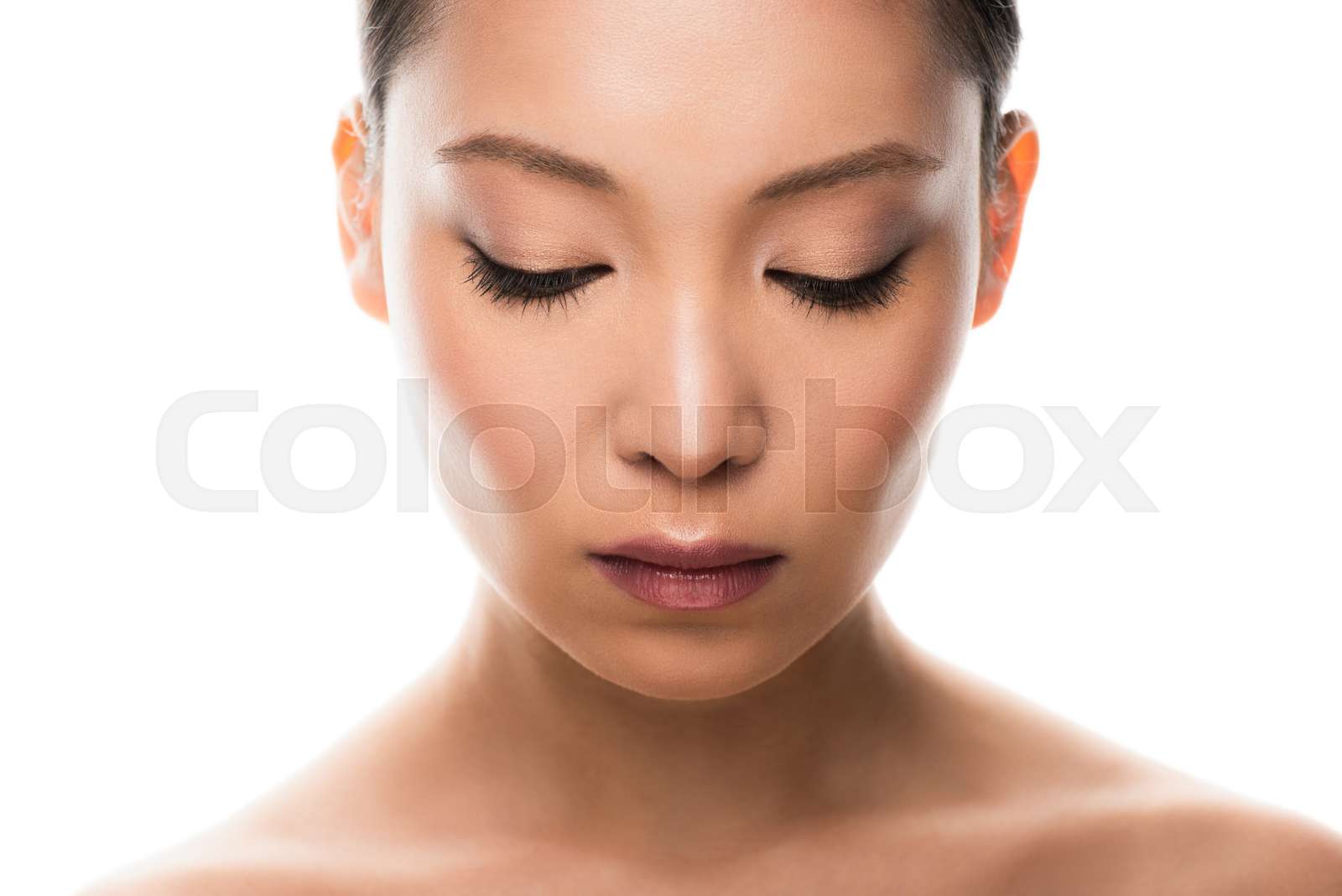 beautiful young asian woman with perfect skin looking down, isolated on ...