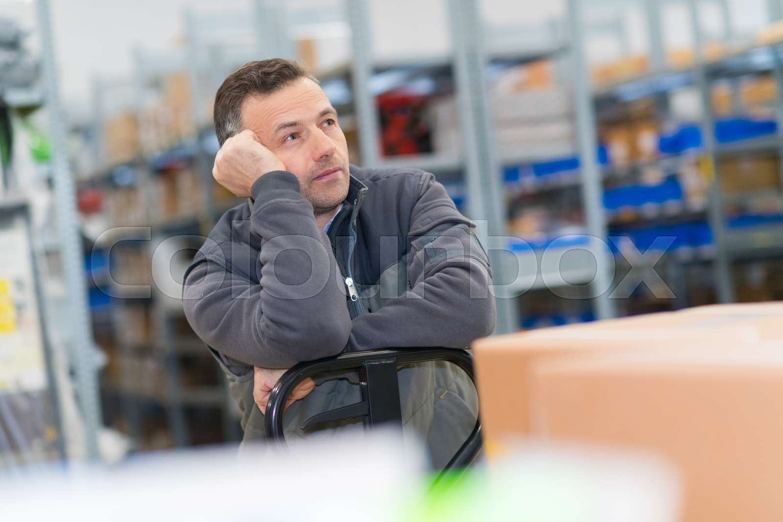 bored warehouse worker | Stock image | Colourbox