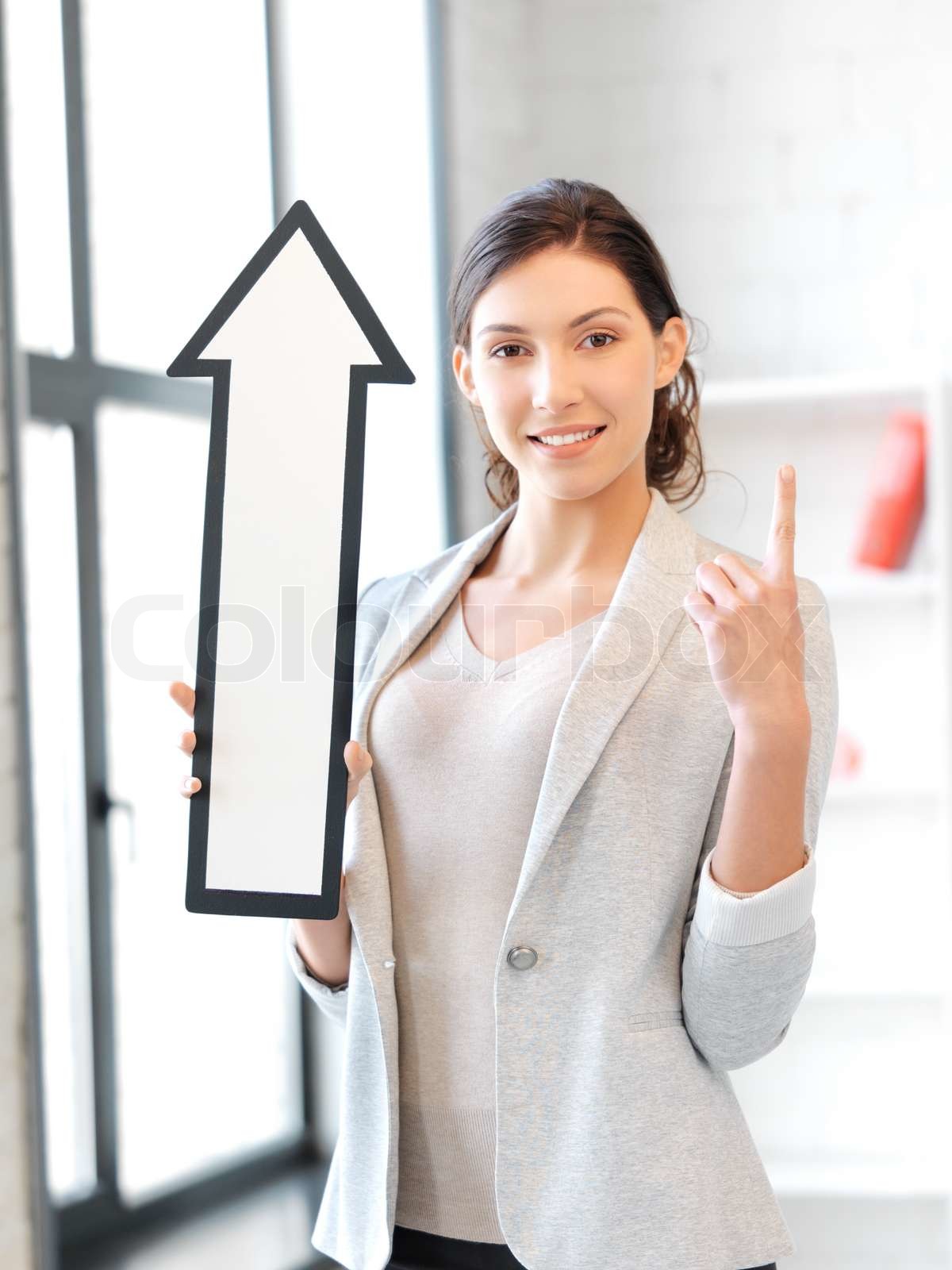 businesswoman with direction arrow sign | Stock image | Colourbox