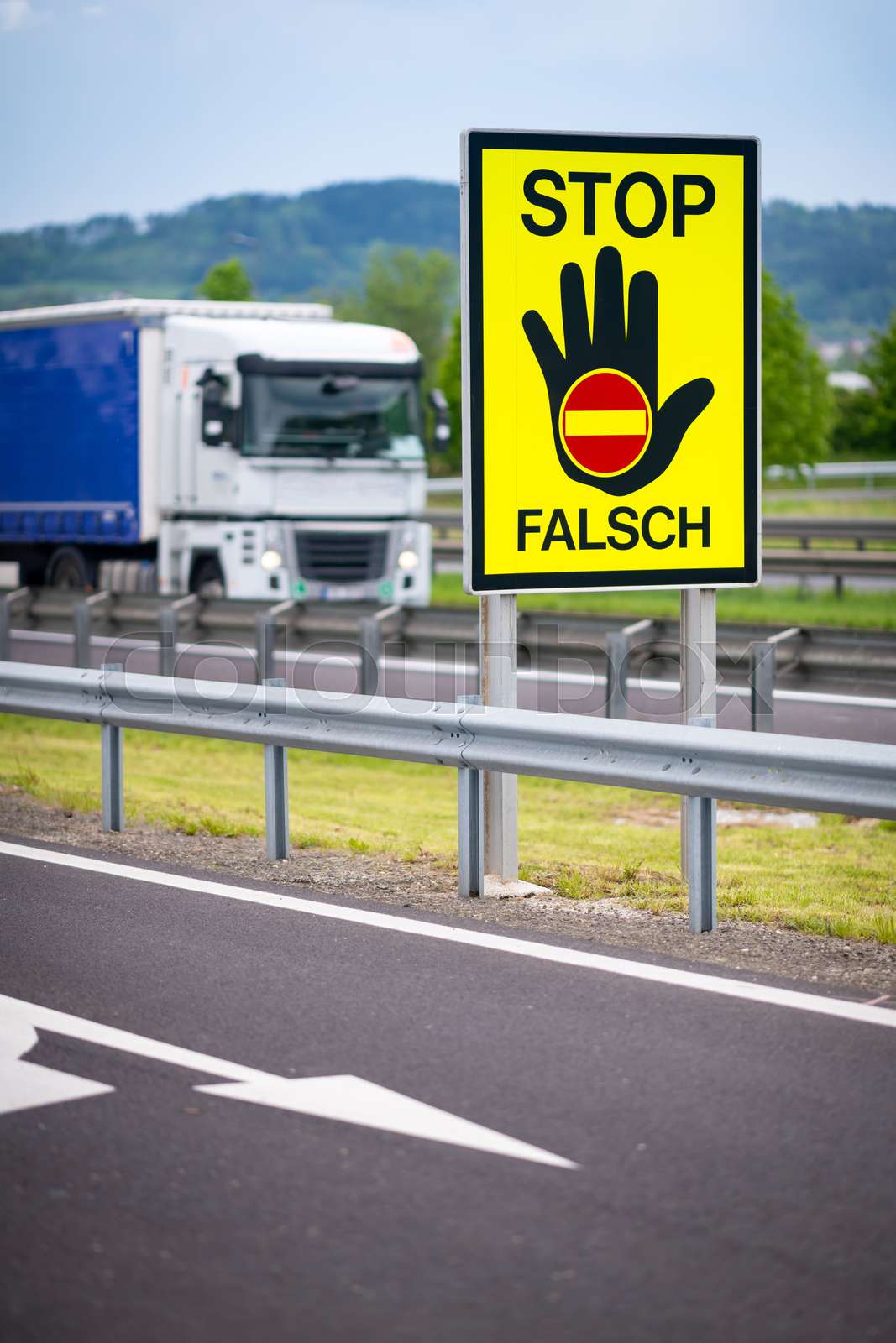 Truck on the highway in the austrian countryside with the STOP/ FALSCH ...