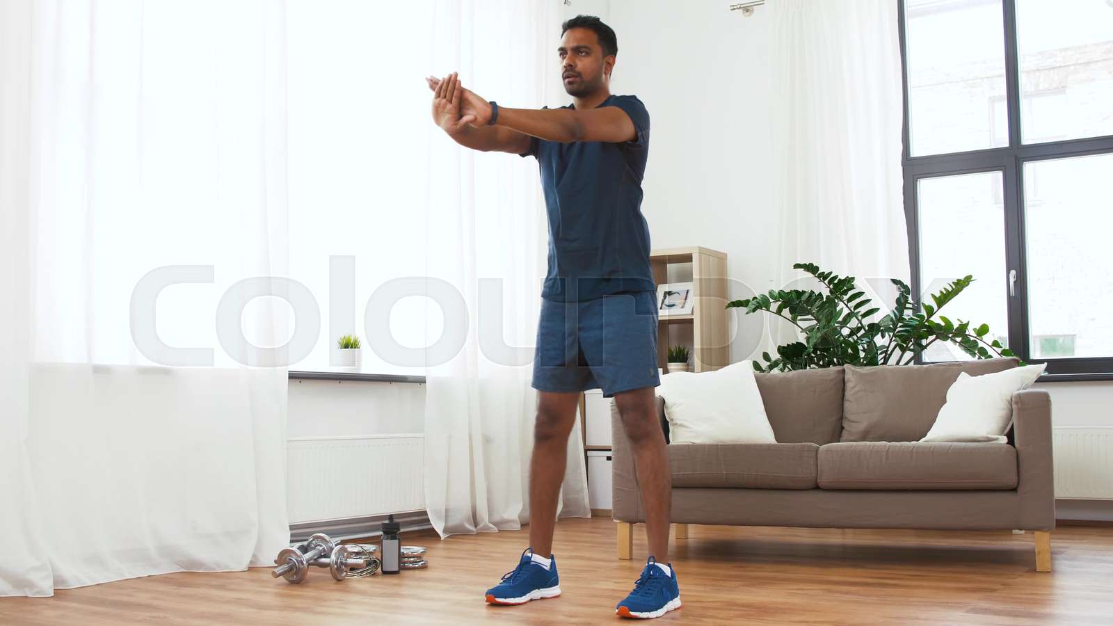 indian man exercising and doing squats at home | Stock video | Colourbox