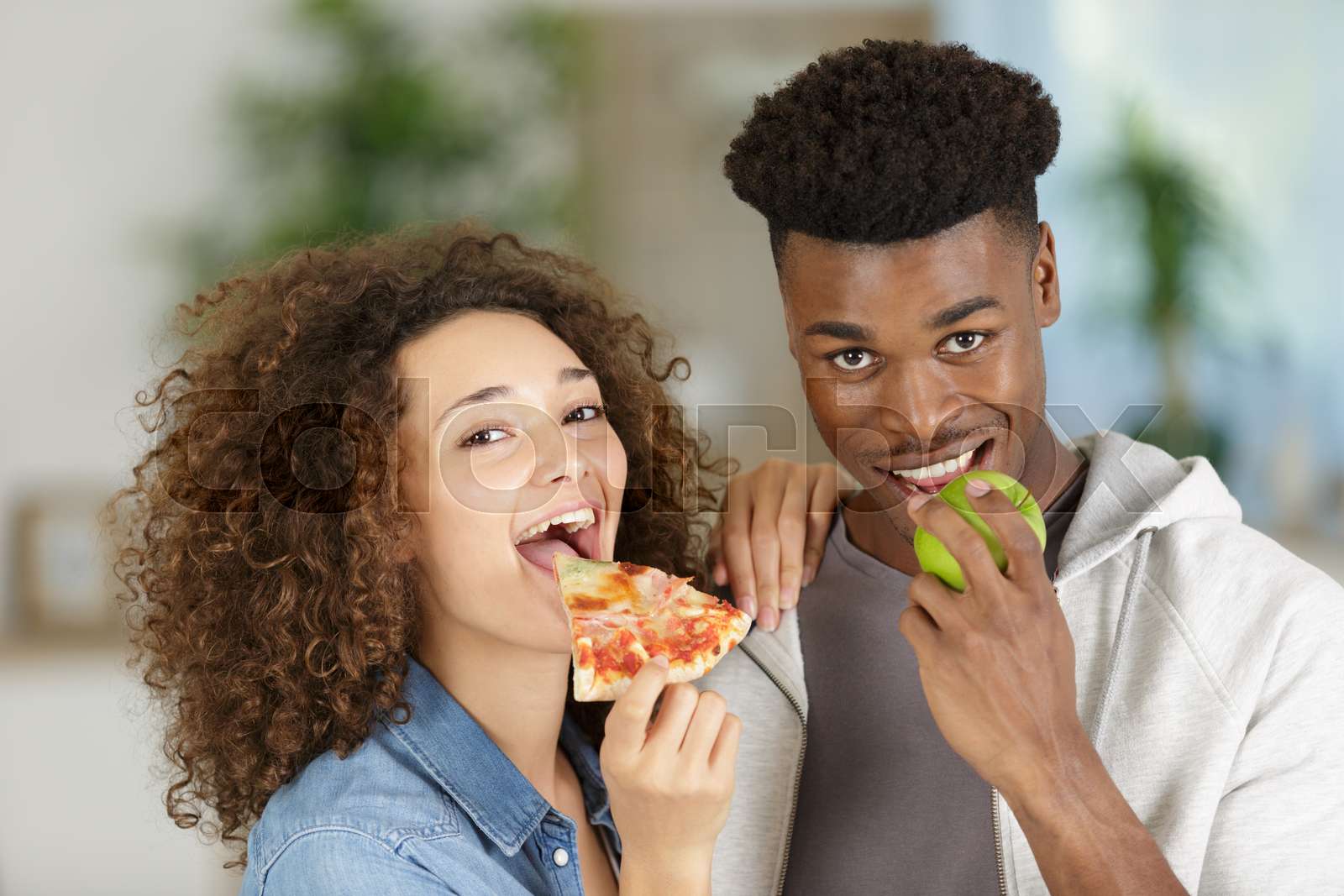girlfriend eating pizza and boyfriend eating apple | Stock image ...