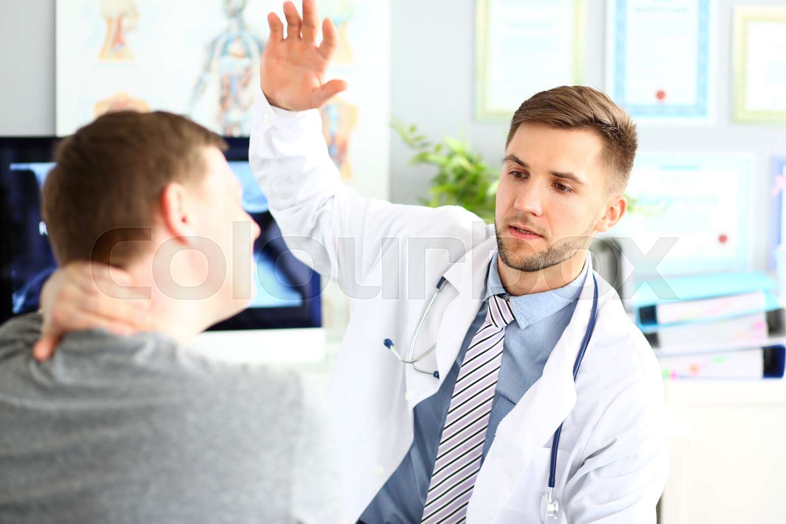Doctor showing exercises for health | Stock image | Colourbox
