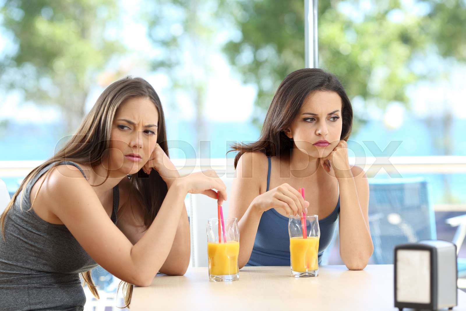 Angry friends ignoring each other on vacation | Stock image | Colourbox