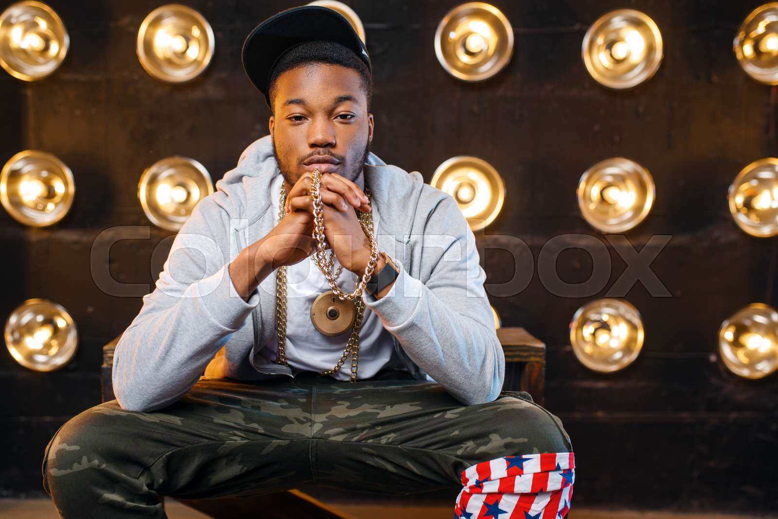 Black rapper in cap poses, perfomance on stage | Stock image | Colourbox