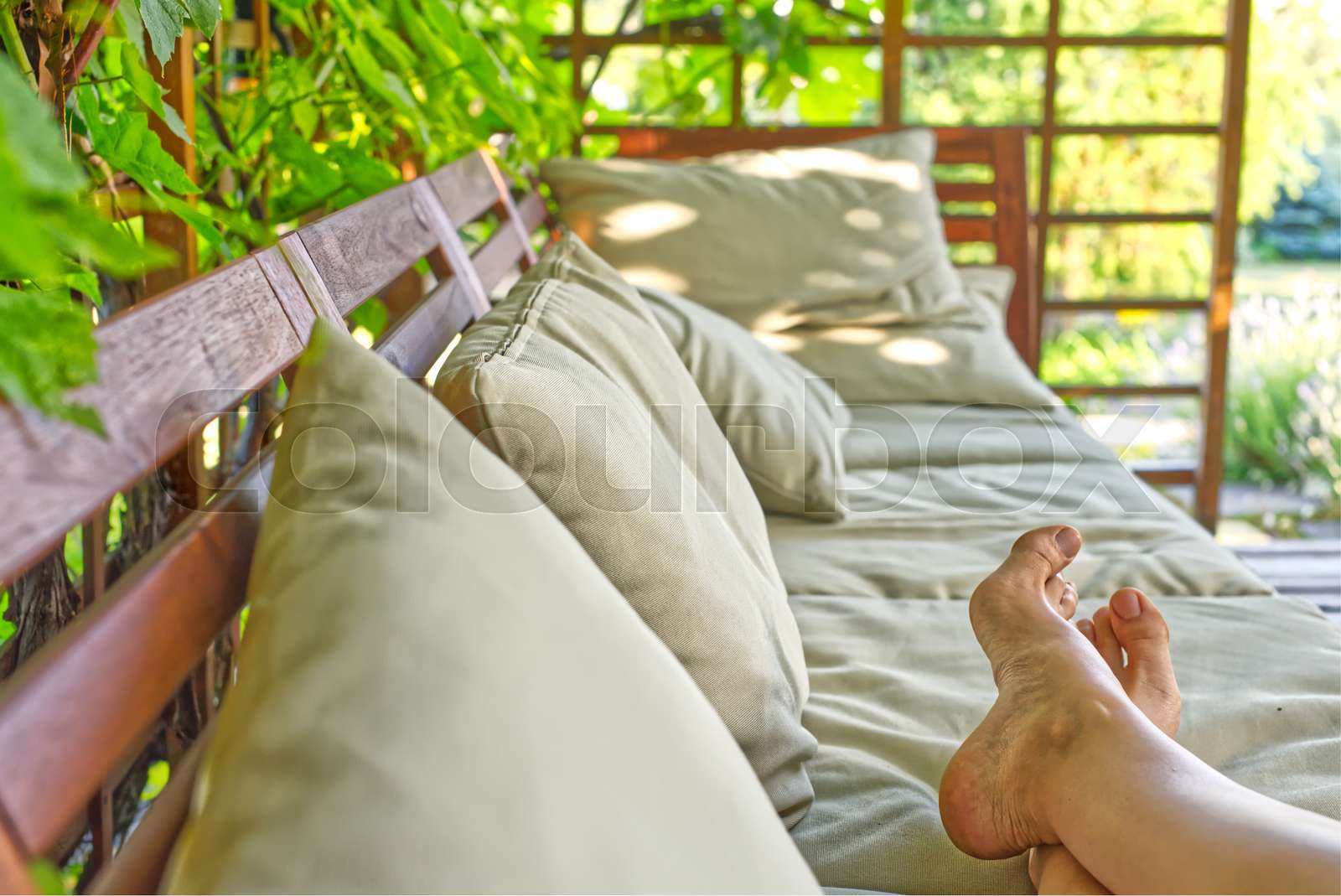 Siesta nap on outdoor couch | Stock image | Colourbox