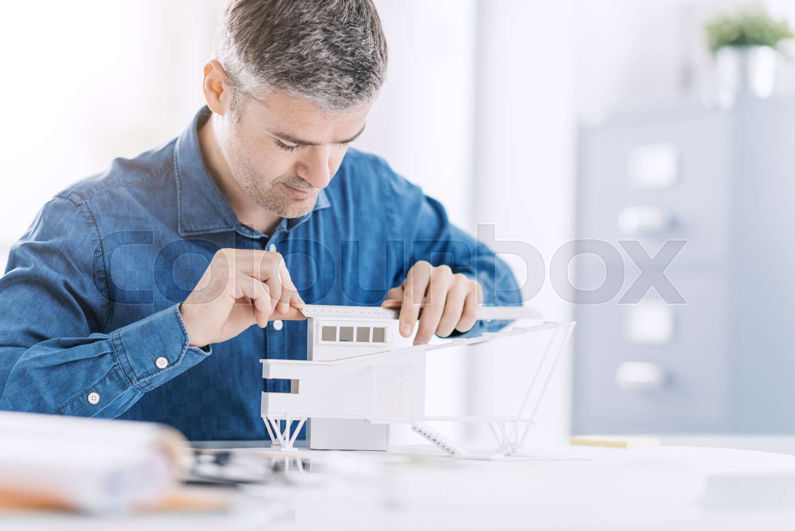 Architect assembling an architectural model | Stock image | Colourbox