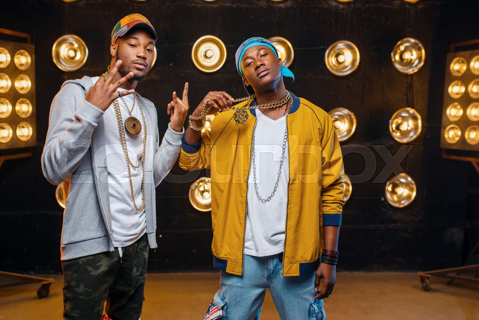 Two black rappers in caps, artists poses on stage | Stock image | Colourbox