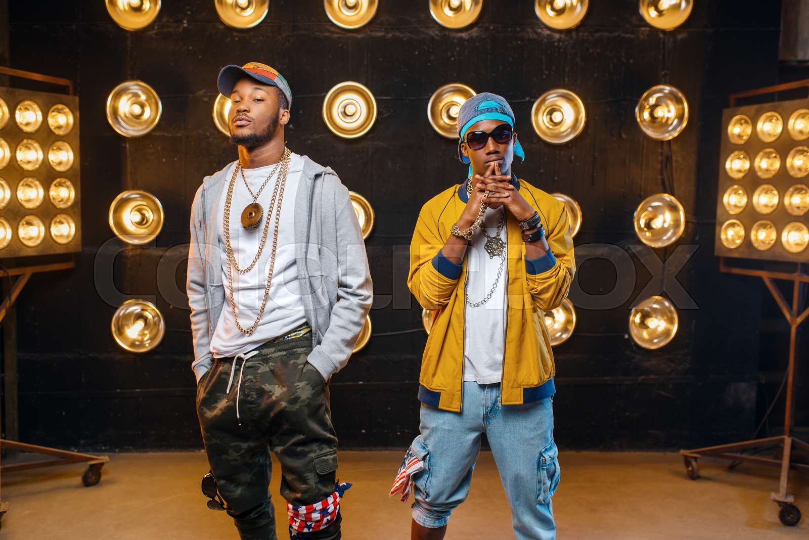 Two black rappers in caps, perfomance on stage | Stock image | Colourbox