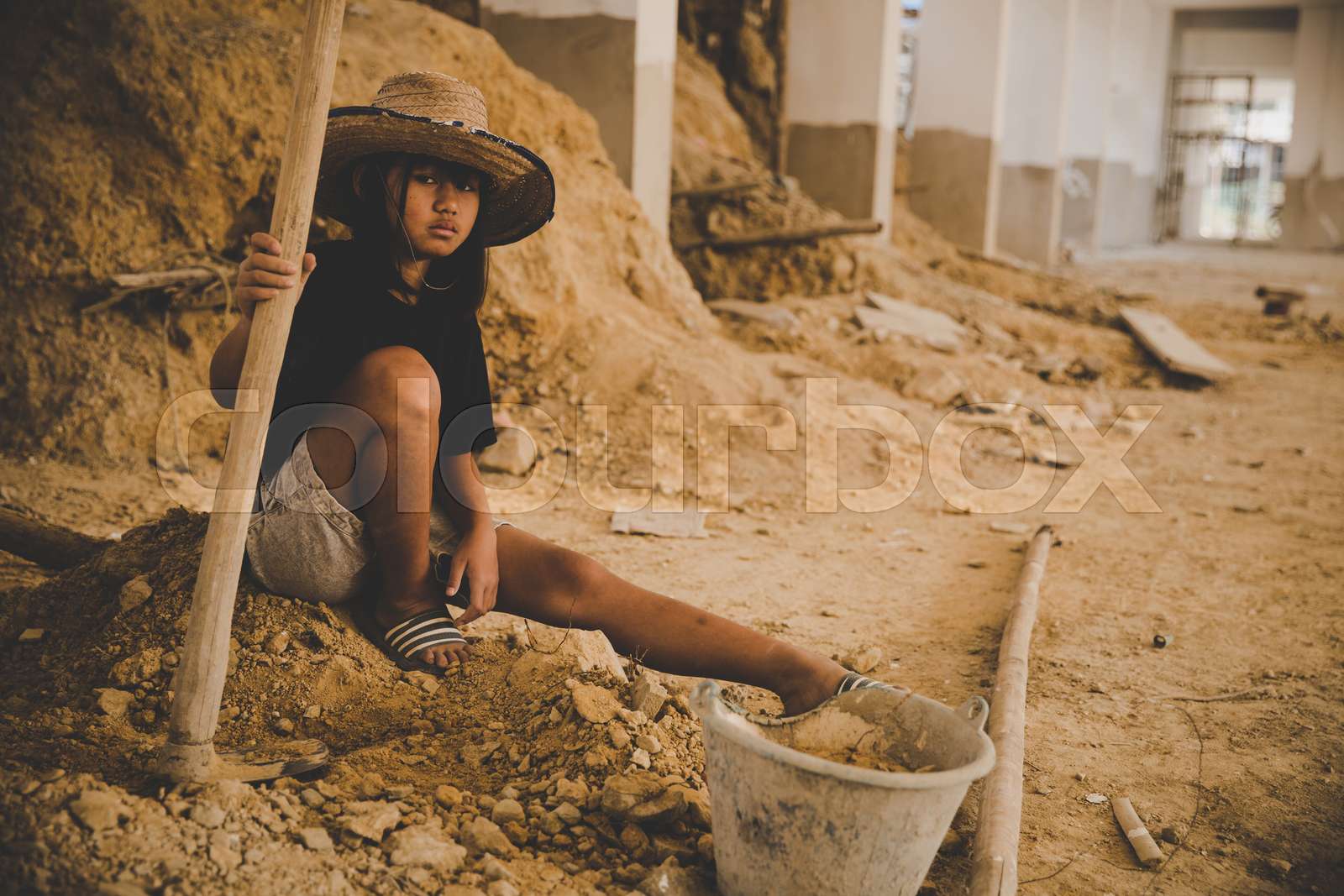 Little girl labor working in commercial building structure, World Day ...