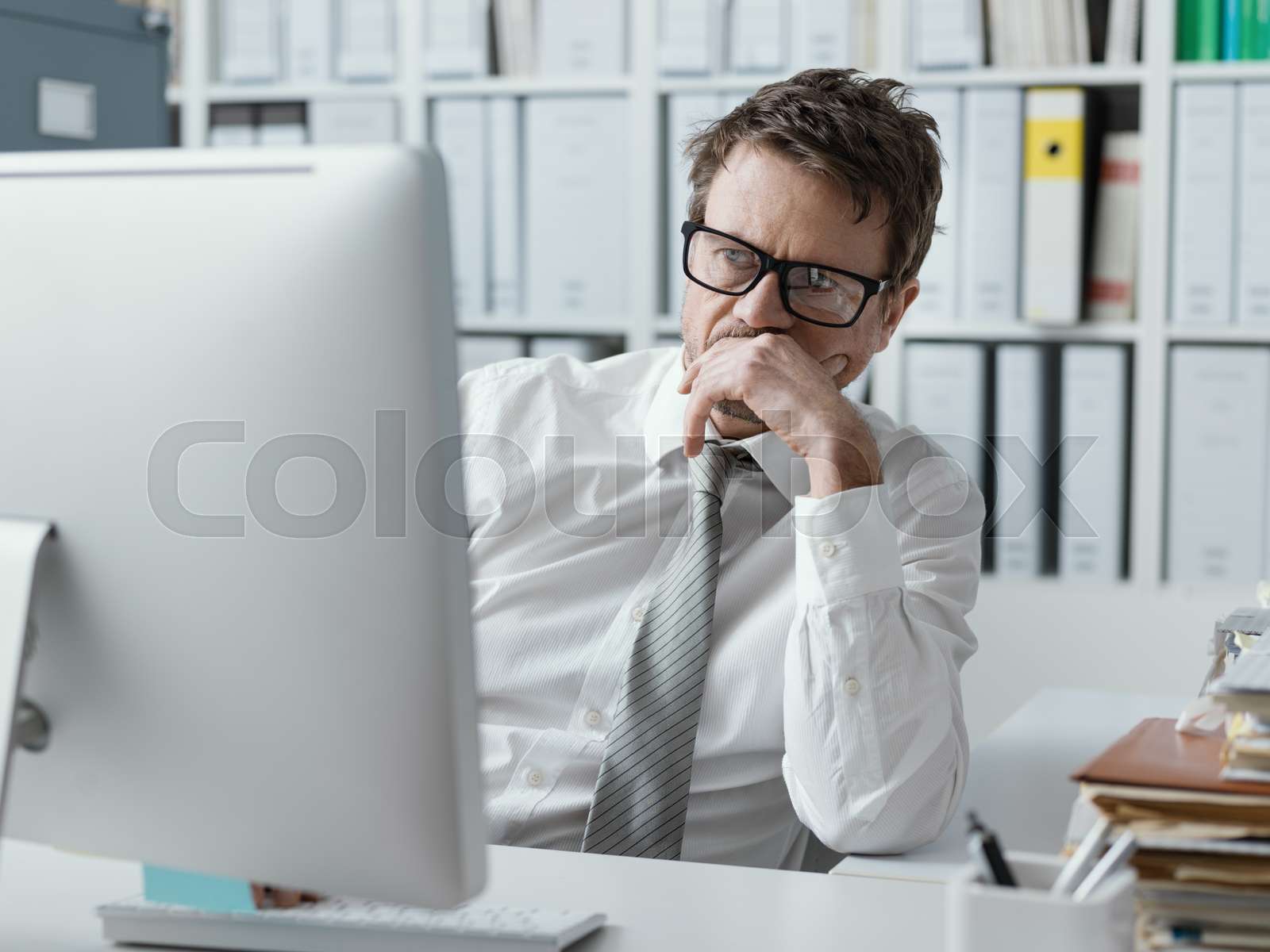 Pensive businessman staring at the computer screen | Stock image ...